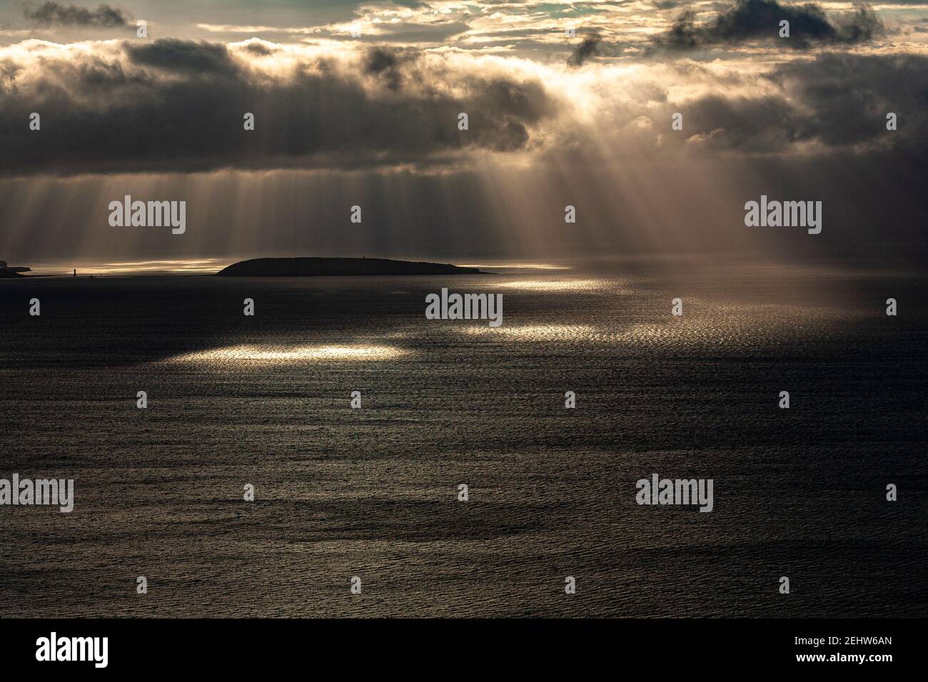 Puffin Island, Anglesey, North Wales with clouds and sunbeams Stock ...