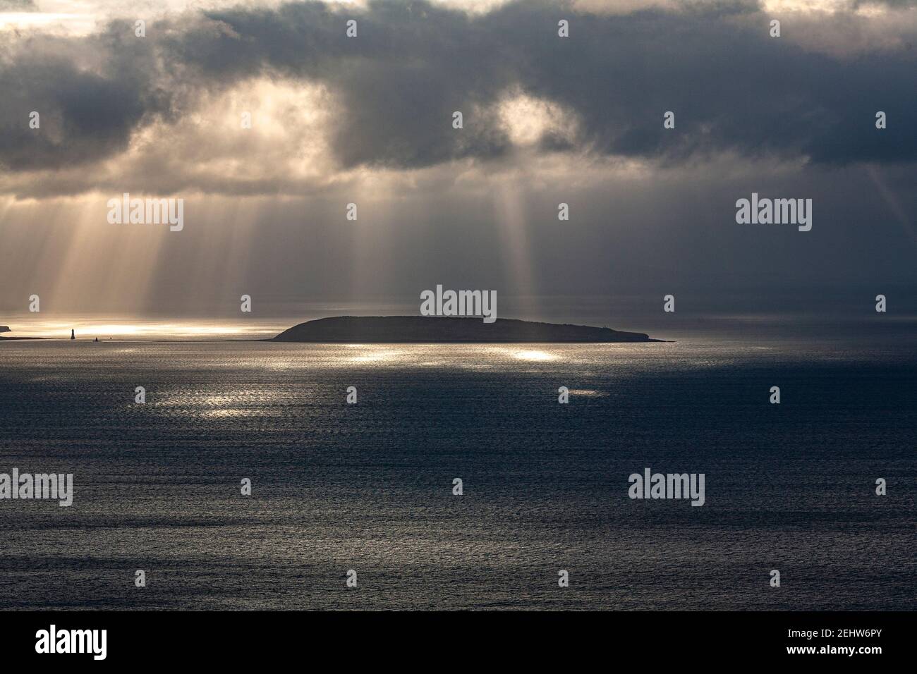 Puffin Island, Anglesey, North Wales with clouds and sunbeams Stock ...