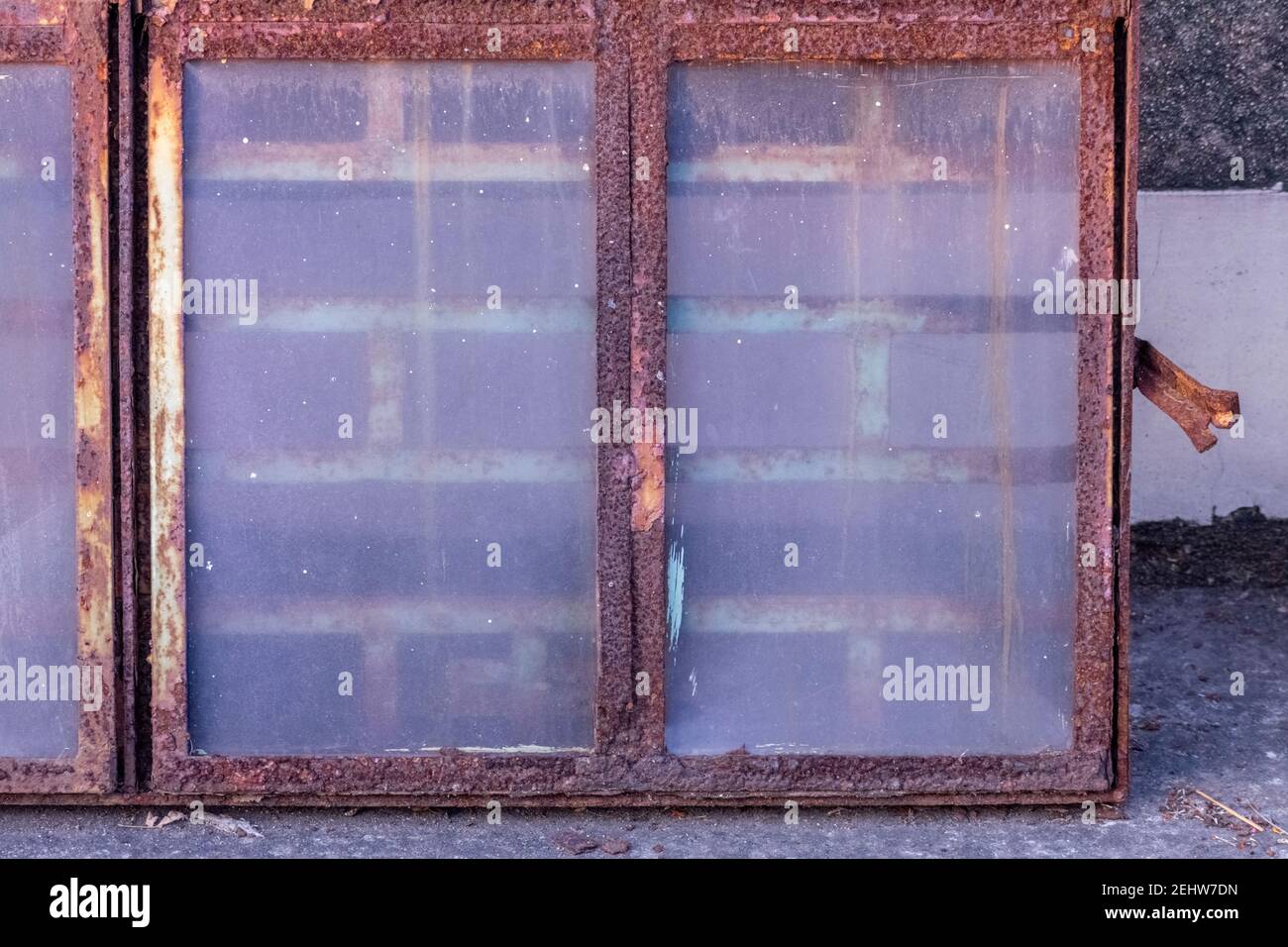 old and abandoned window panel made with iron and fiber glass getting ...