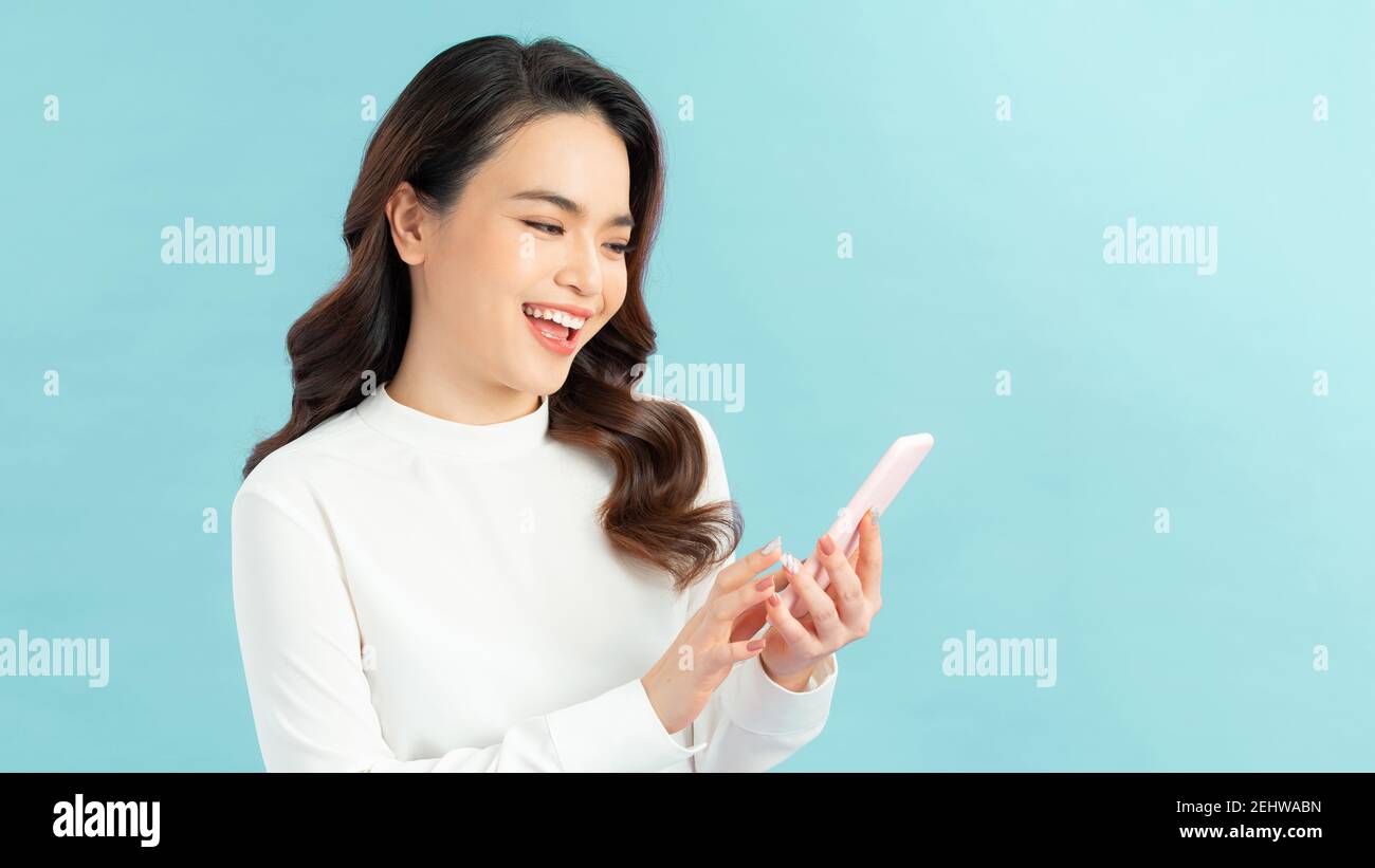 Portrait of beautiful woman using smartphone, isolated Stock Photo - Alamy