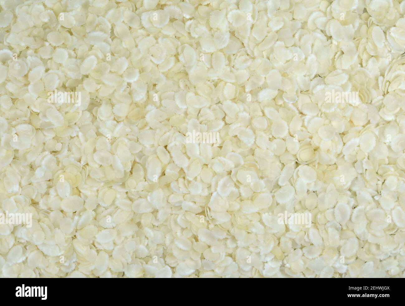 flattened rice flakes as a background Stock Photo - Alamy