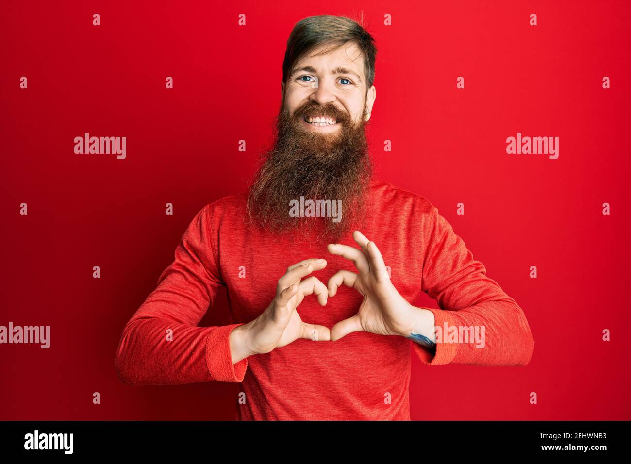 Redhead man with long beard wearing casual clothes smiling in love ...