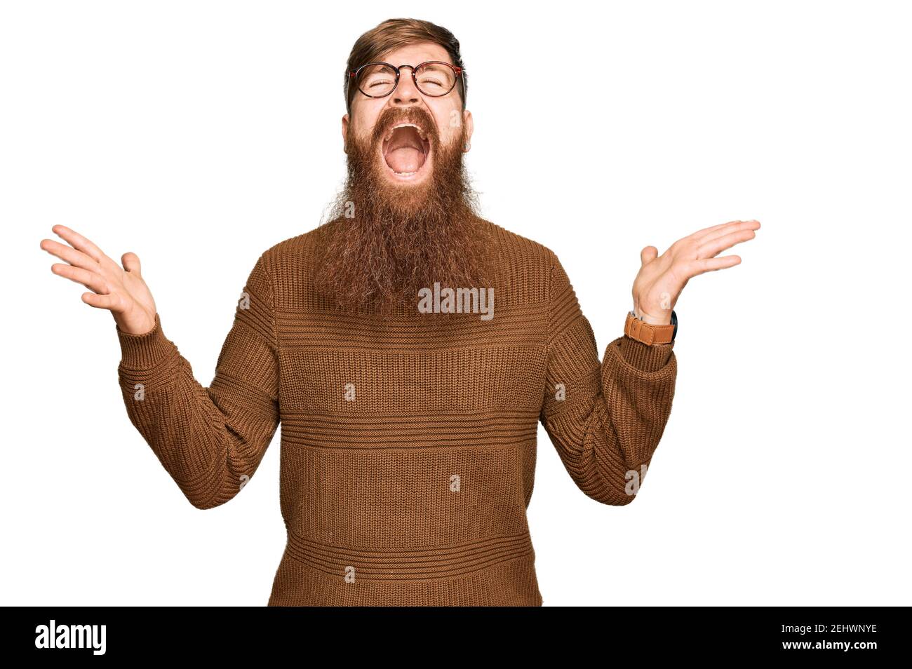 Young irish redhead man wearing casual clothes and glasses celebrating ...