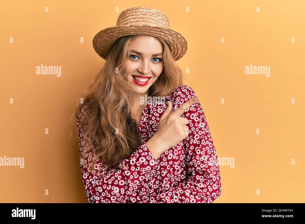 Beautiful blonde caucasian woman wearing summer hat cheerful with a ...