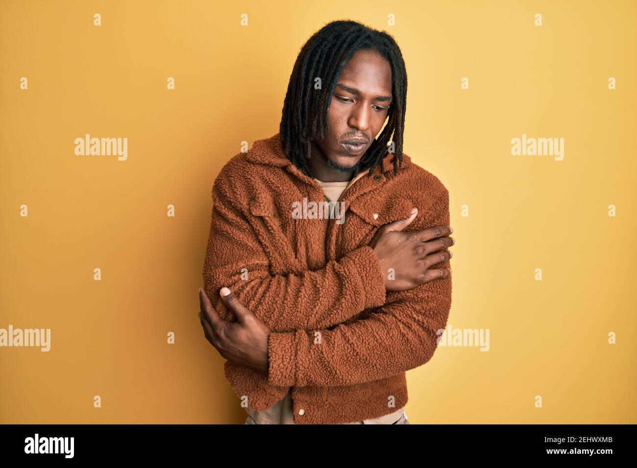African american man with braids wearing brown retro jacket shaking and ...