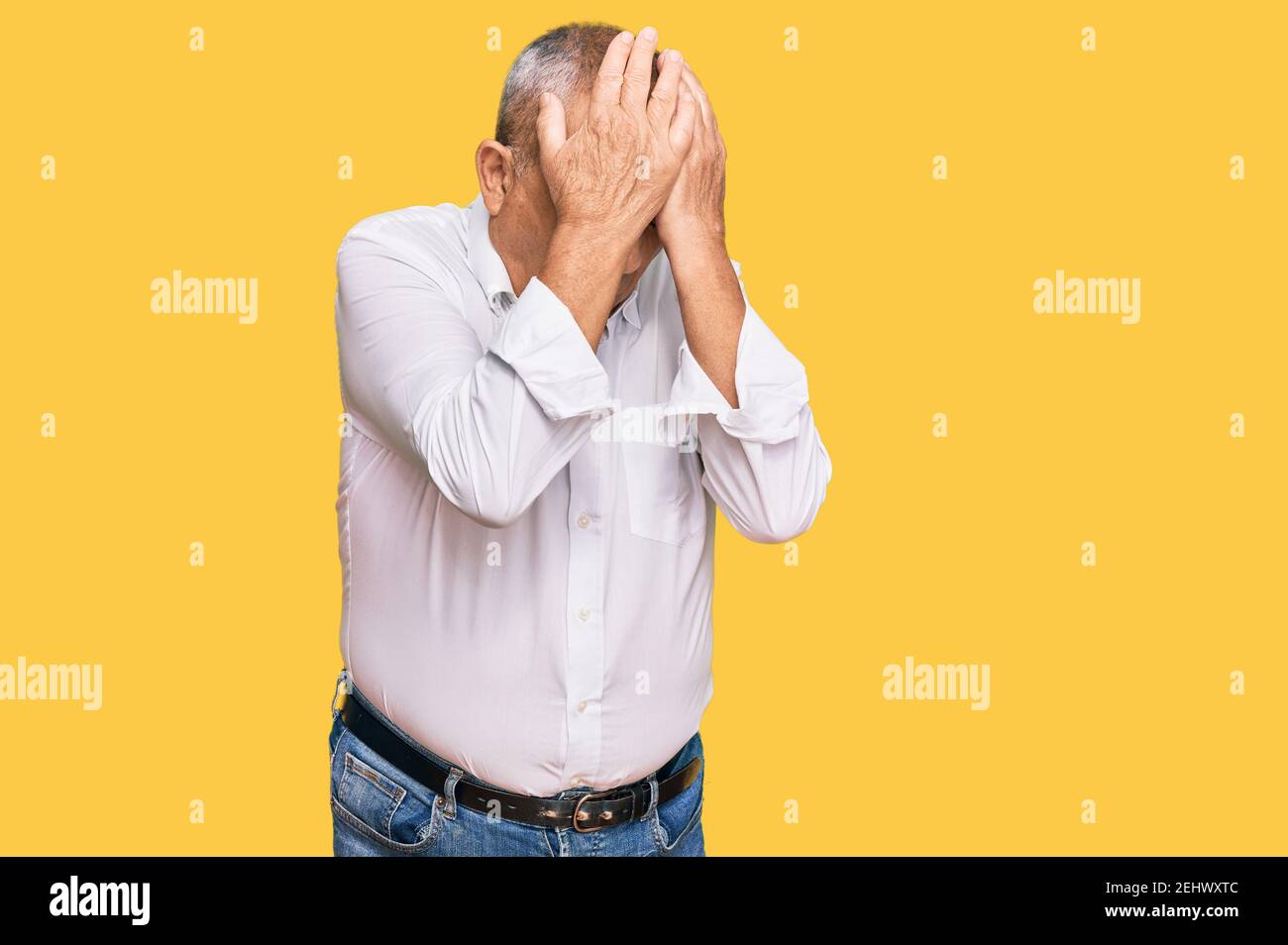 Handsome senior man wearing elegant white shirt with sad expression ...