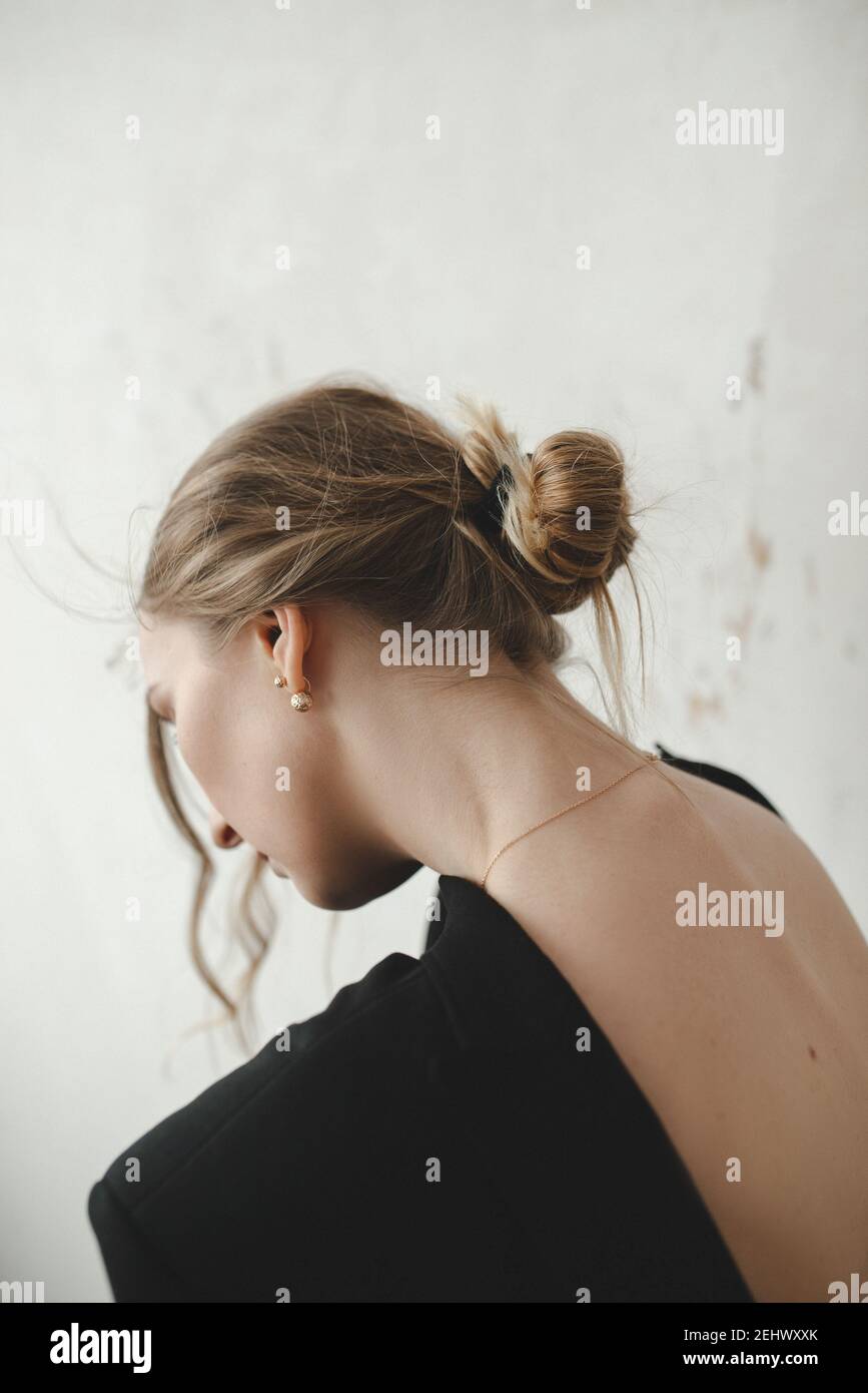 Back view of a sad young blonde female with head down Stock Photo - Alamy