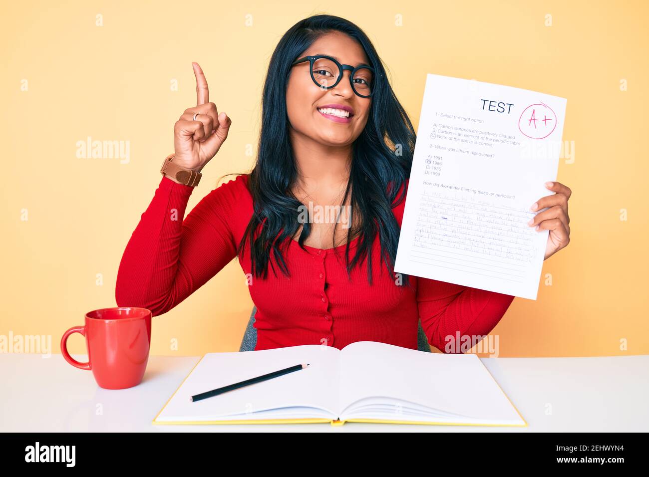 Beautiful latin young woman with long hair showing a passed exam ...
