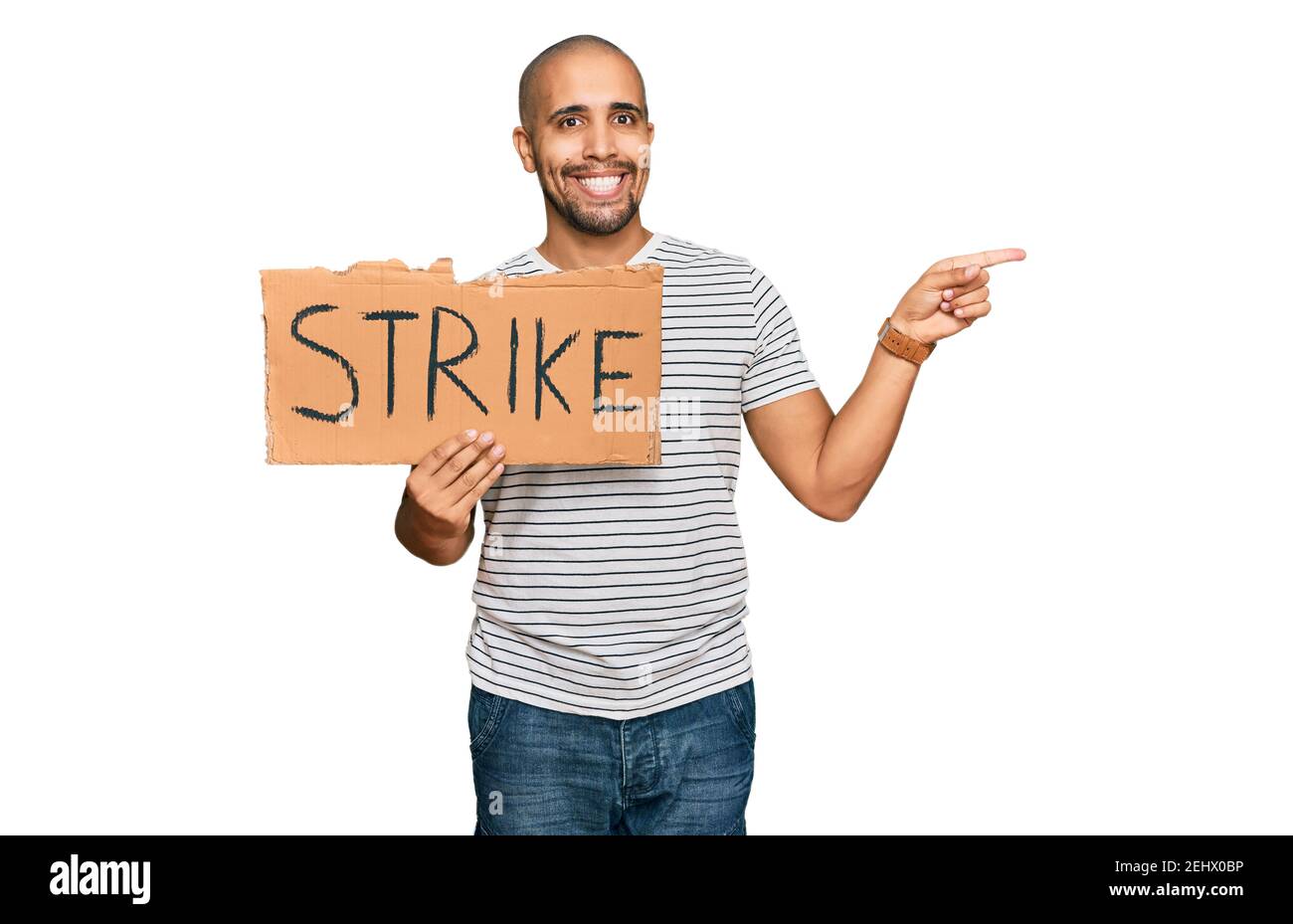 Hispanic adult man holding strike banner cardboard smiling happy ...