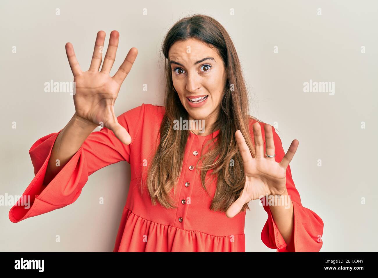 Young beautiful woman wearing casual clothes afraid and terrified with ...