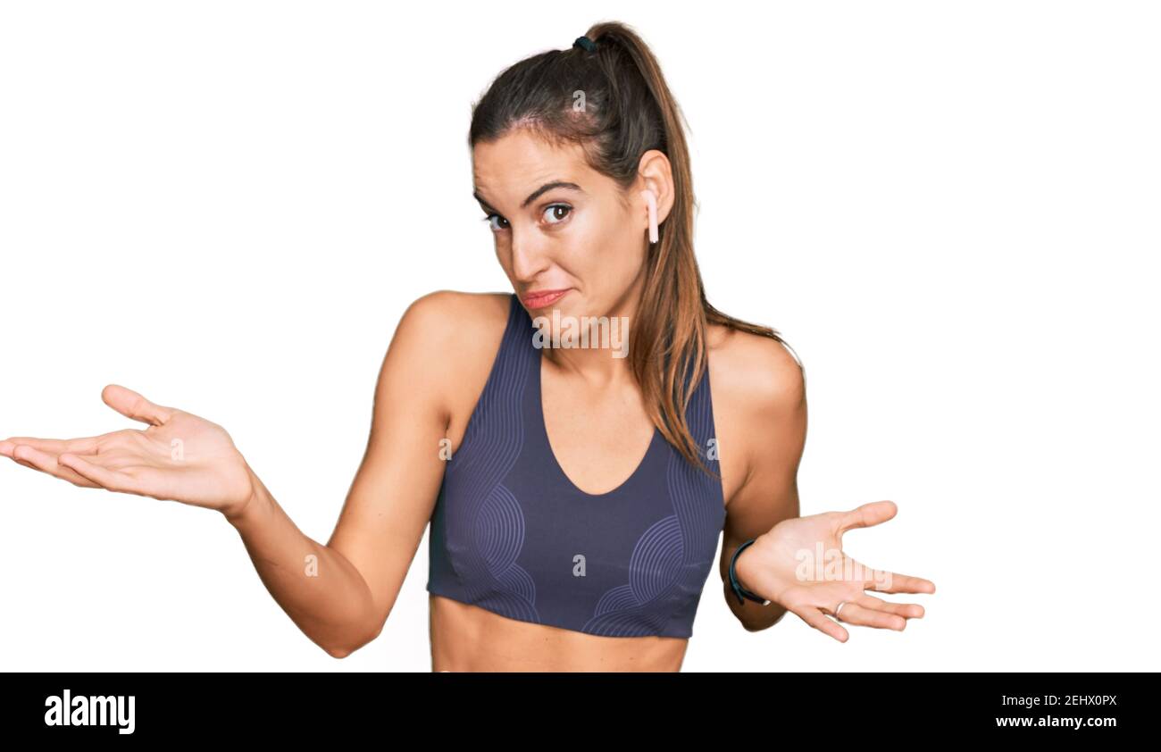 Young beautiful woman wearing sportswear clueless and confused ...