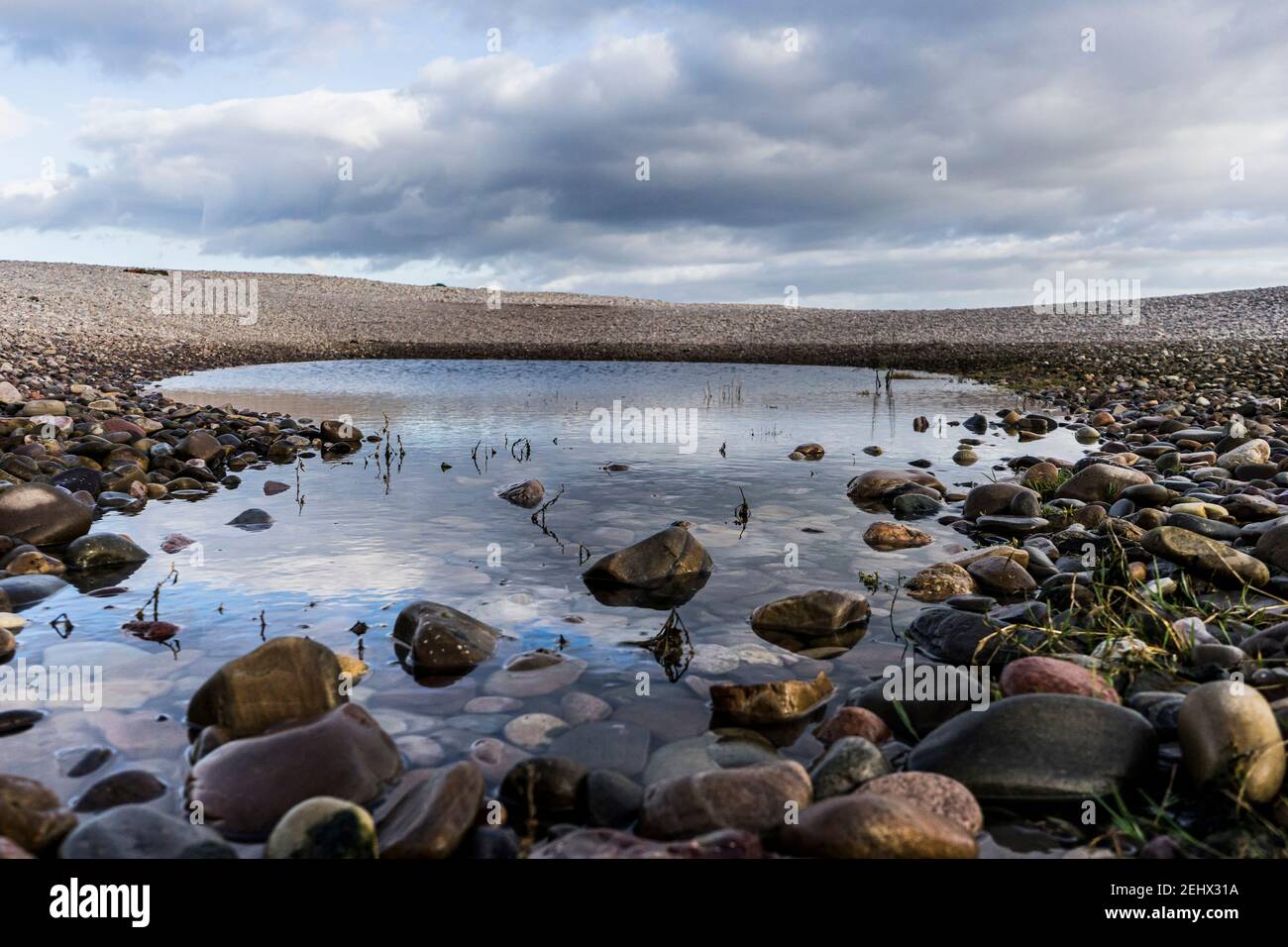 Reflection of blue sky in beach puddles at Spey Bay low tide Stock ...