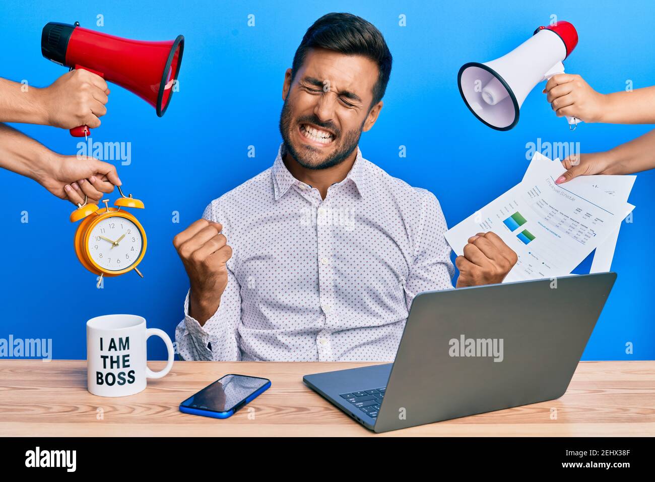 Handsome hispanic man working at the office being stressed out very ...