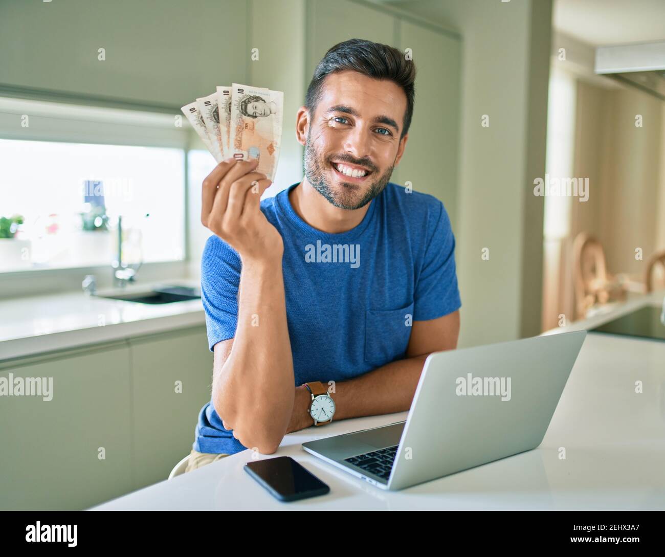 Young handsome man smiling happy holding england pounds banknotes at ...