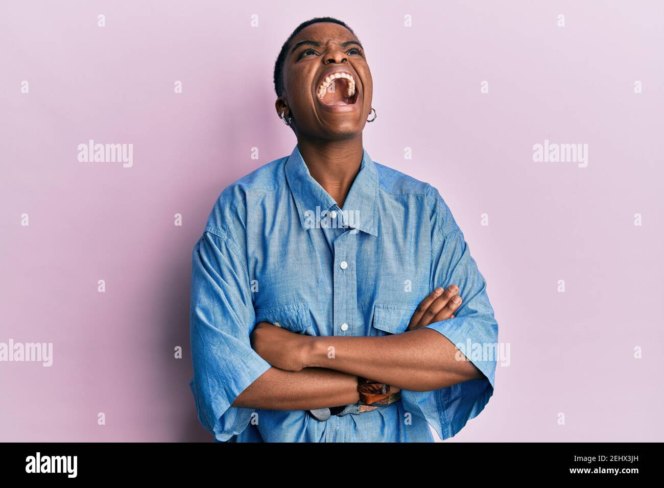 Young african american woman with arms crossed gesture angry and mad ...