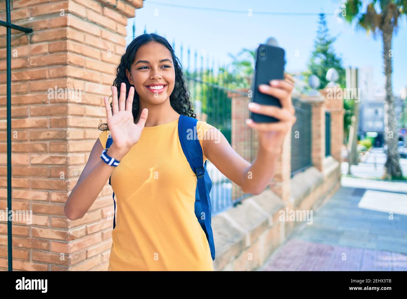 Young african american student girl doing video call using smartphone ...