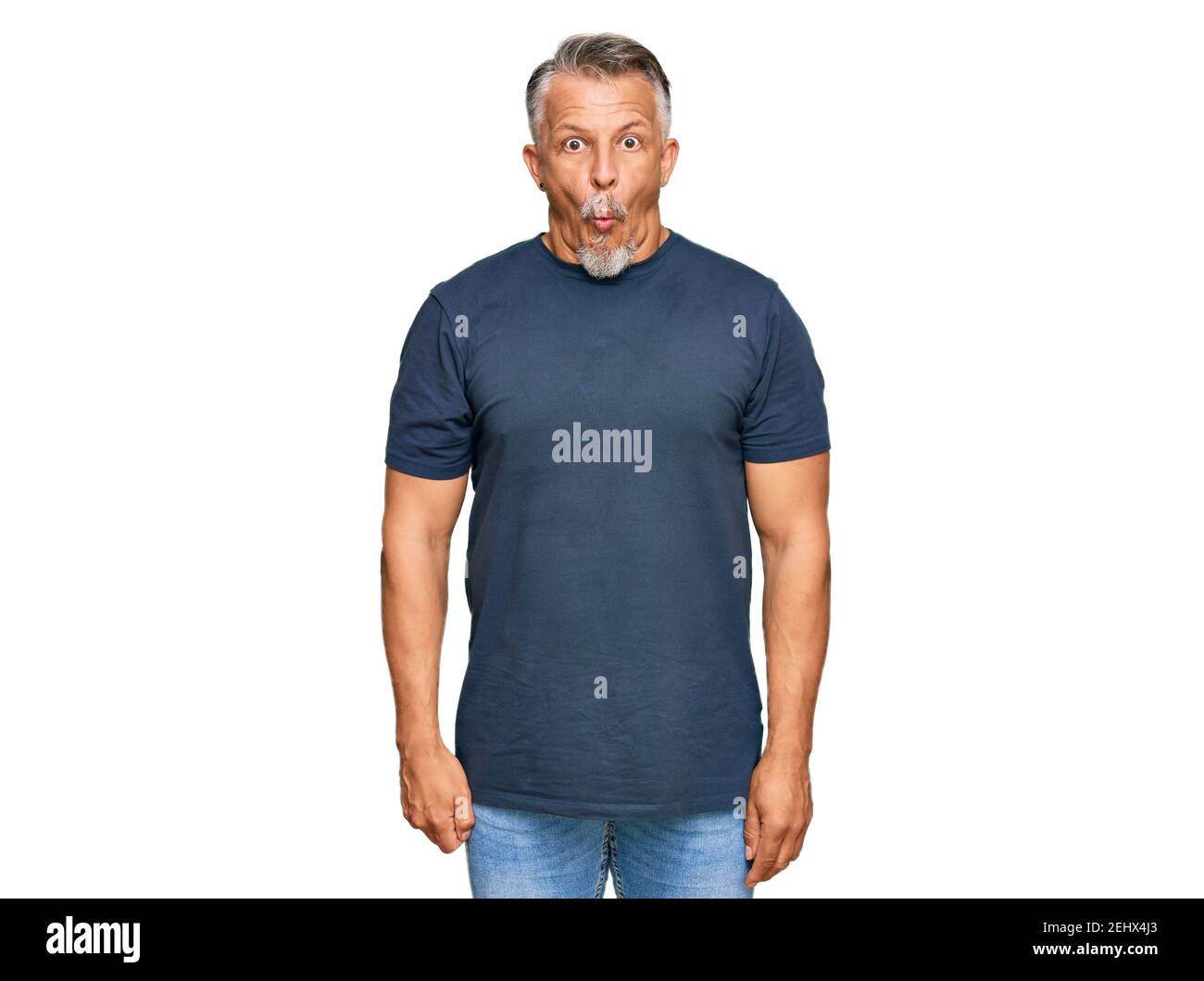 Middle age grey-haired man wearing casual clothes making fish face with ...