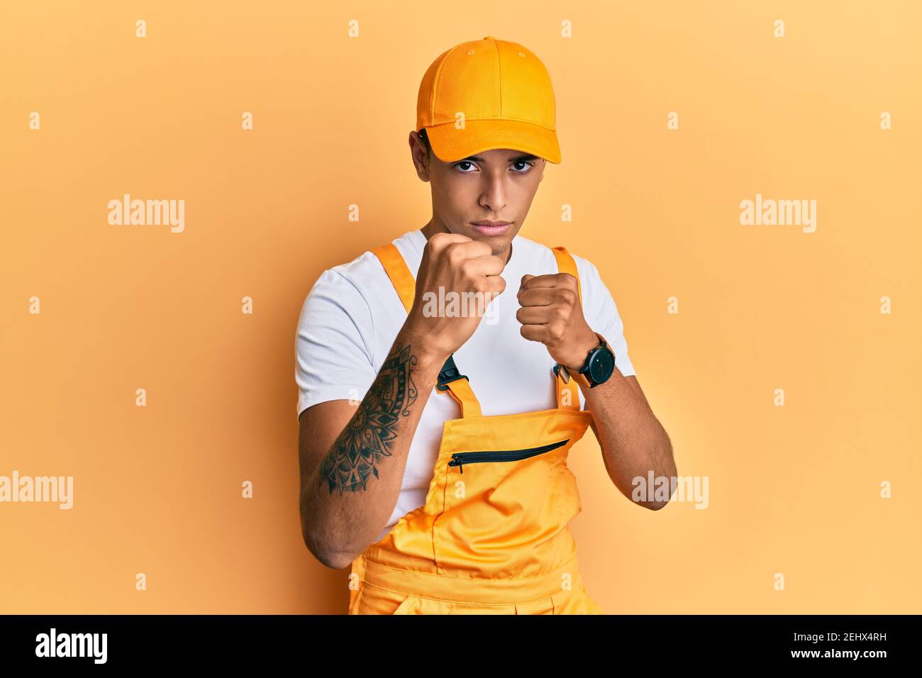 Young handsome african american man wearing handyman uniform over ...