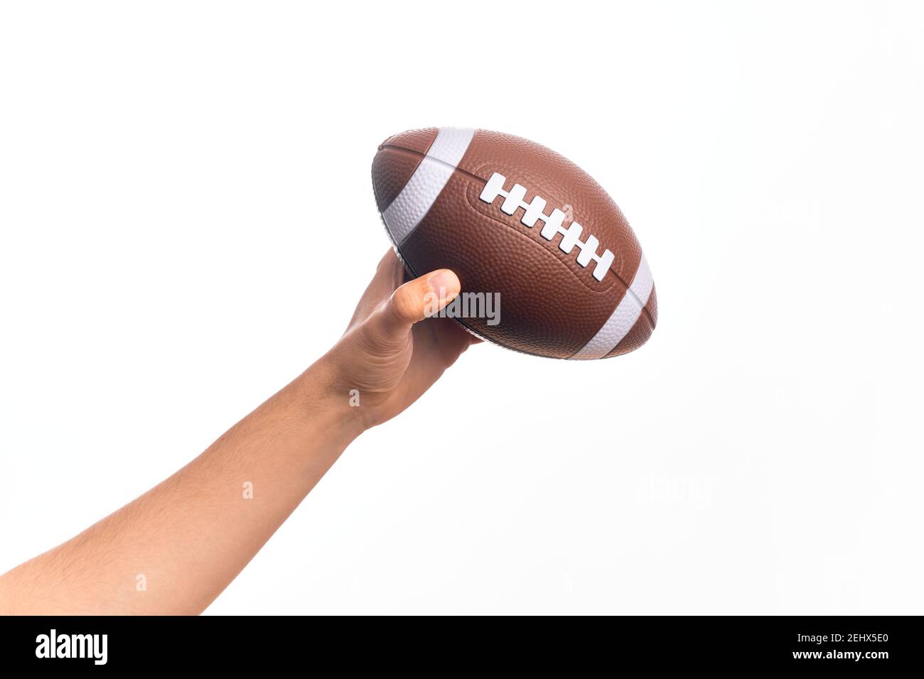 Hand of caucasian young sporty man holding football ball over isolated ...