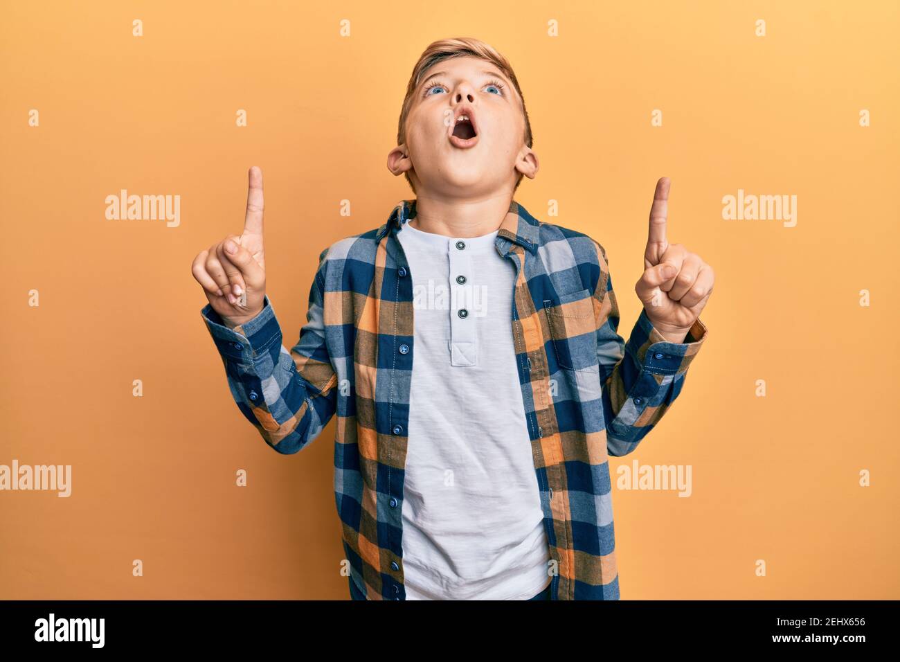 Little caucasian boy kid wearing casual clothes amazed and surprised ...