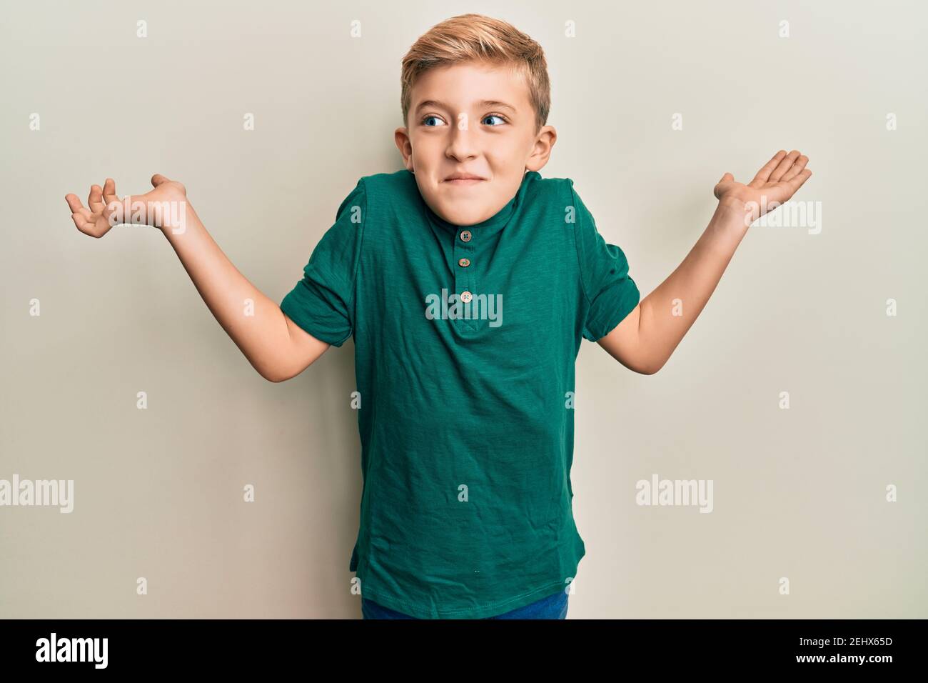 Little caucasian boy kid wearing casual clothes clueless and confused ...