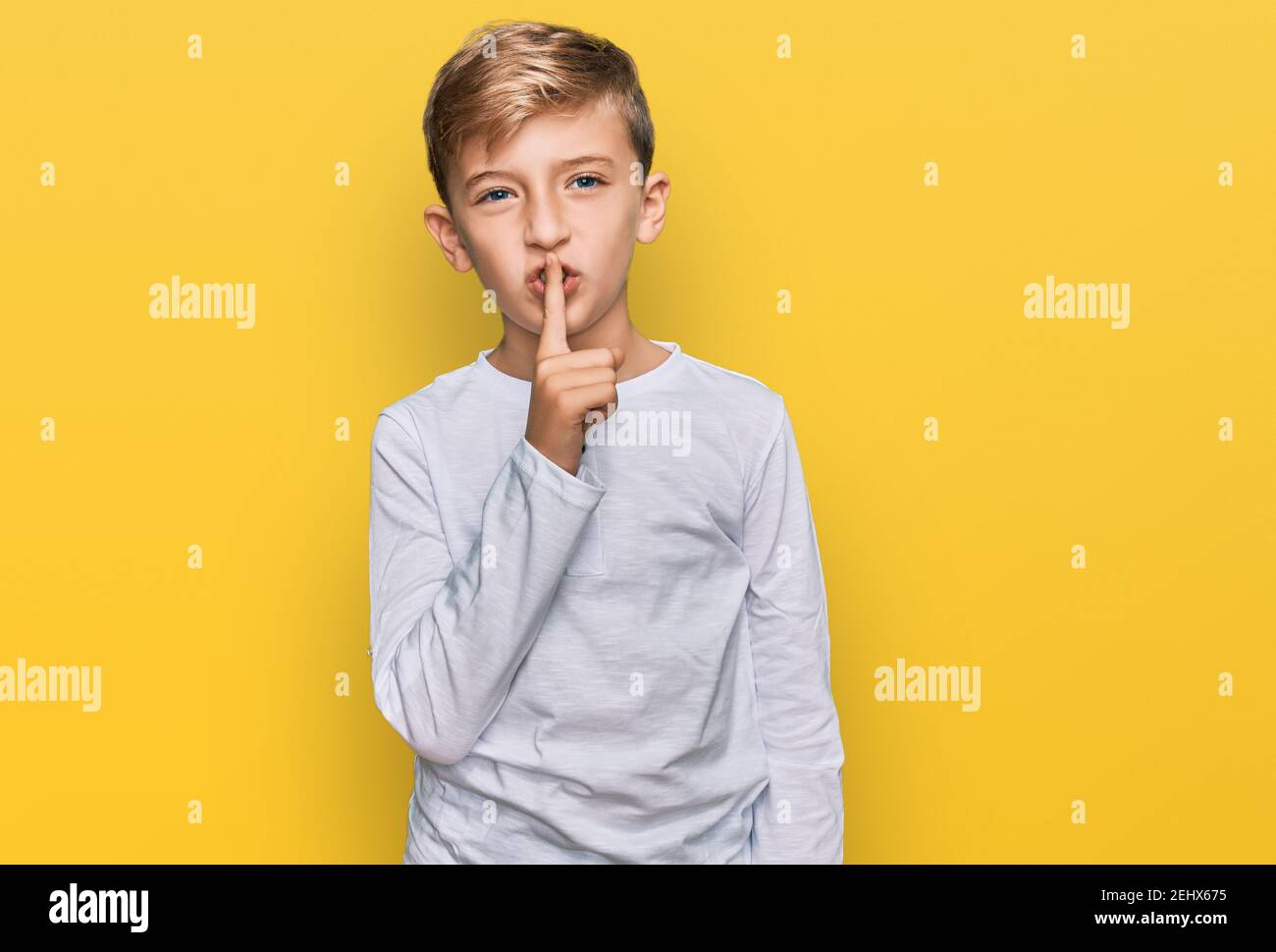 Little caucasian boy kid wearing casual clothes asking to be quiet with ...