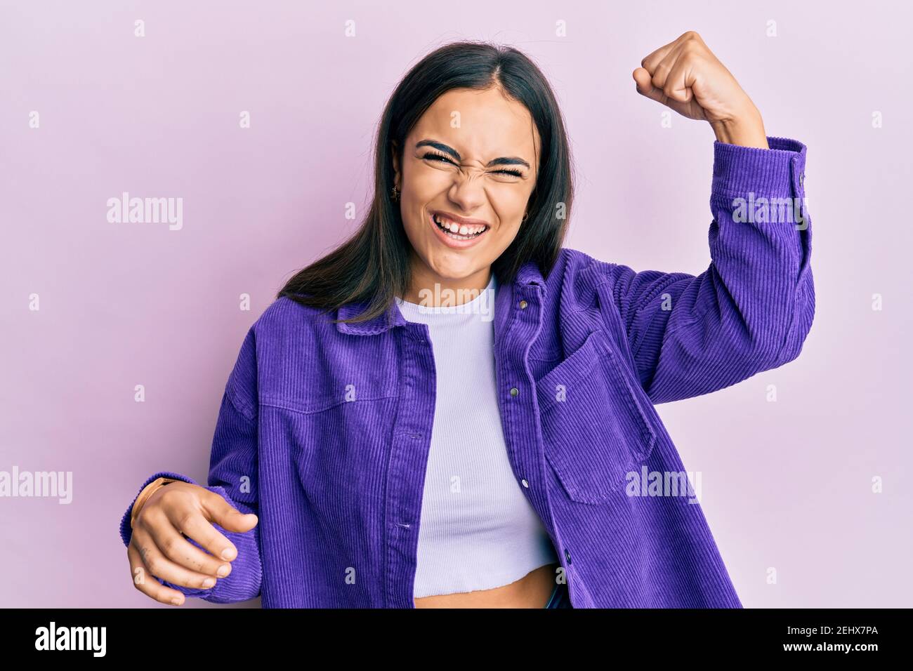 Young brunette woman wearing casual clothes angry and mad raising fist ...