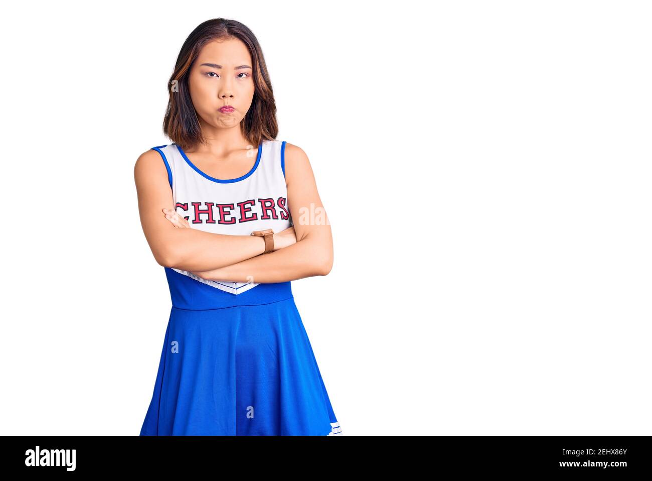 Young beautiful chinese girl wearing cheerleader uniform skeptic and ...