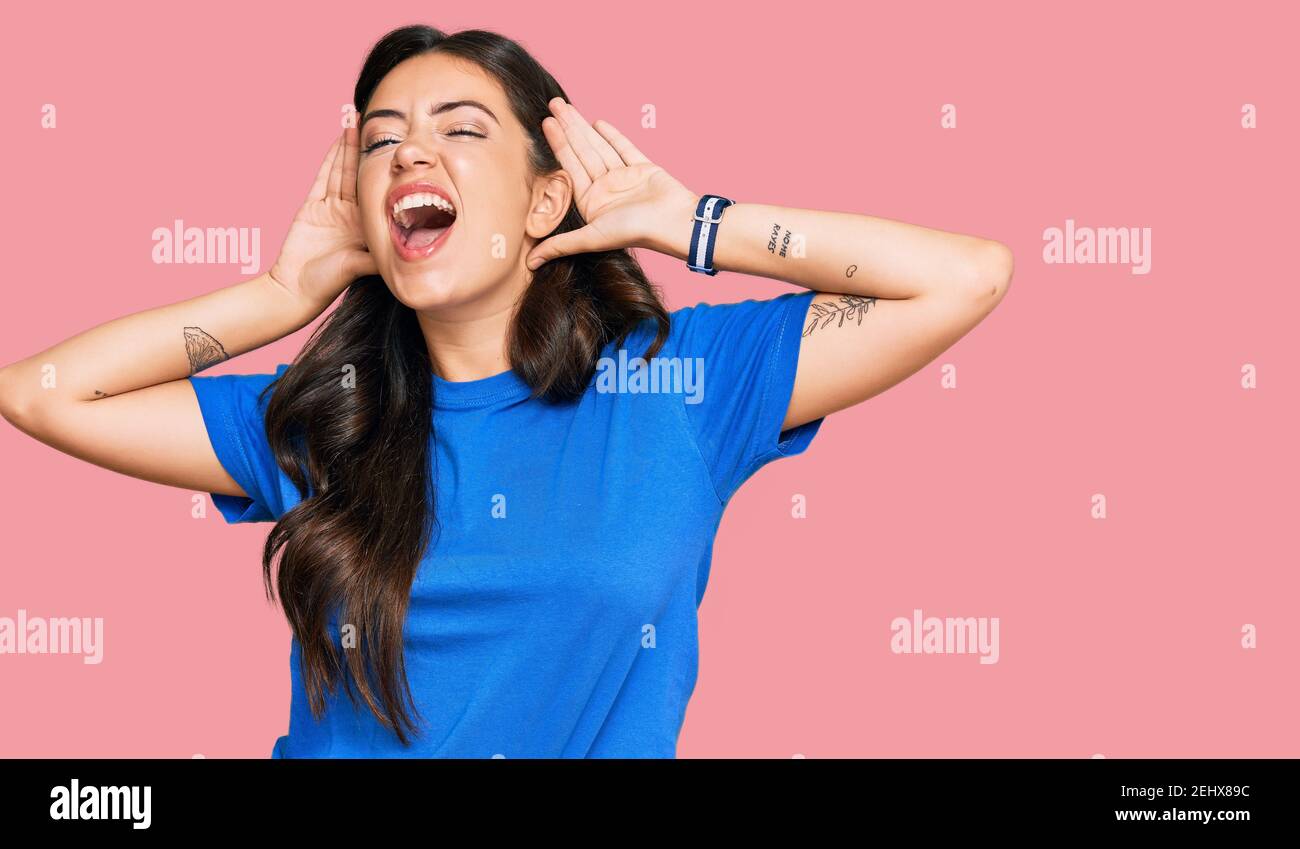 Beautiful brunette young woman wearing casual clothes smiling cheerful ...