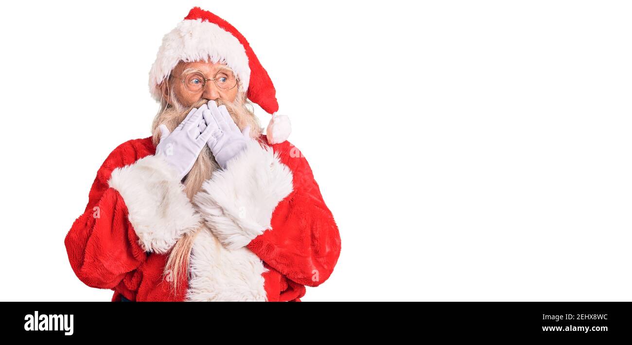 Old senior man with grey hair and long beard wearing traditional santa ...
