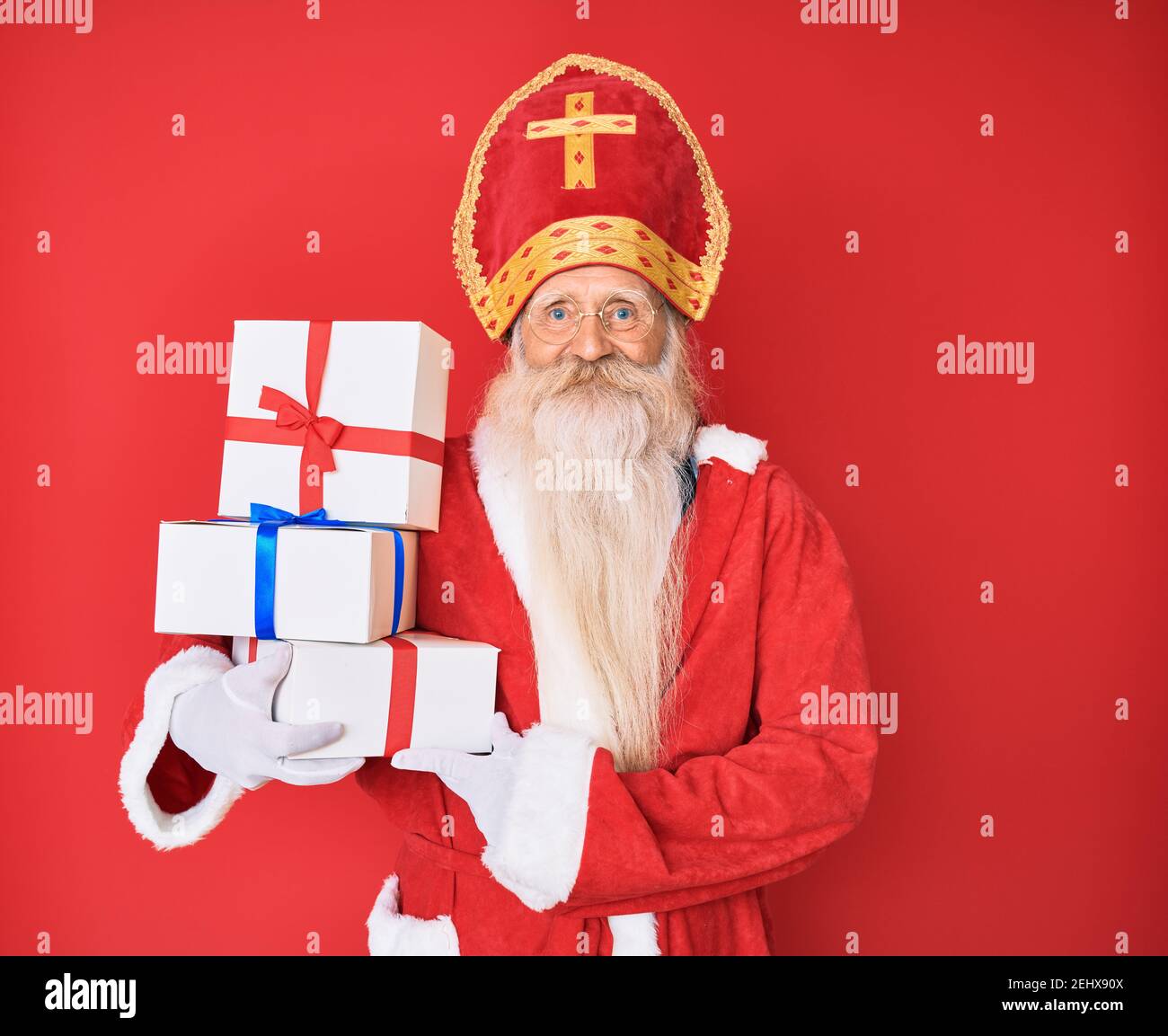 Old senior man with grey hair and long beard wearing saint nicholas ...