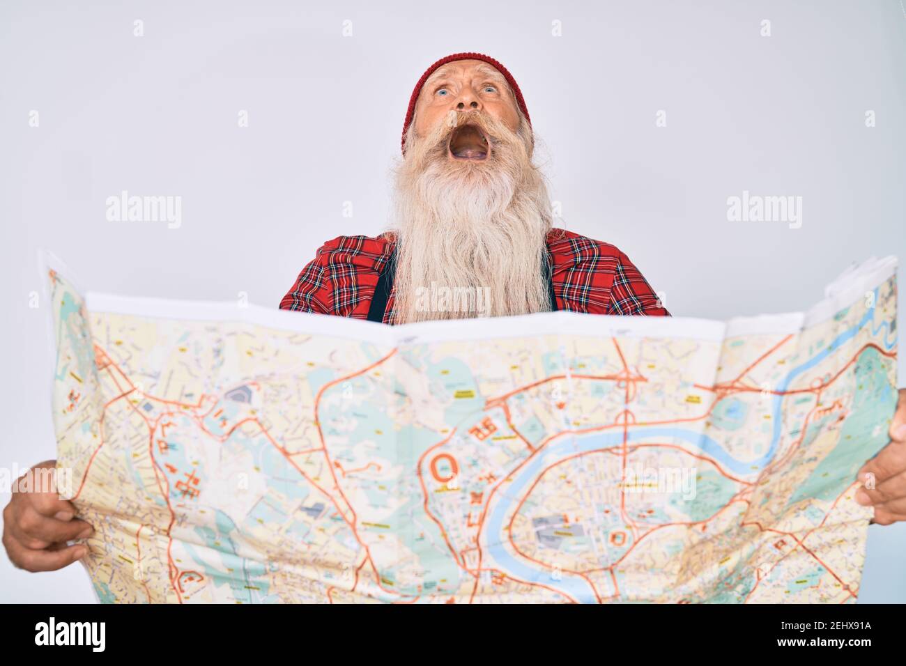 Old senior man with grey hair and long beard holding city map angry and ...