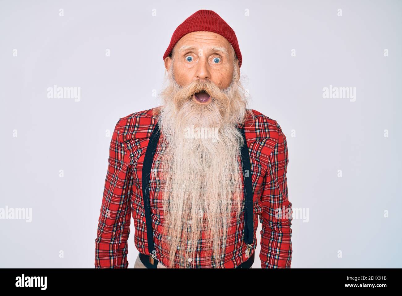 Old senior man with grey hair and long beard wearing hipster look with ...