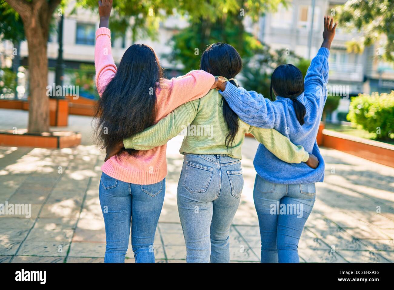 Three african american friends on back view walking at the park Stock ...