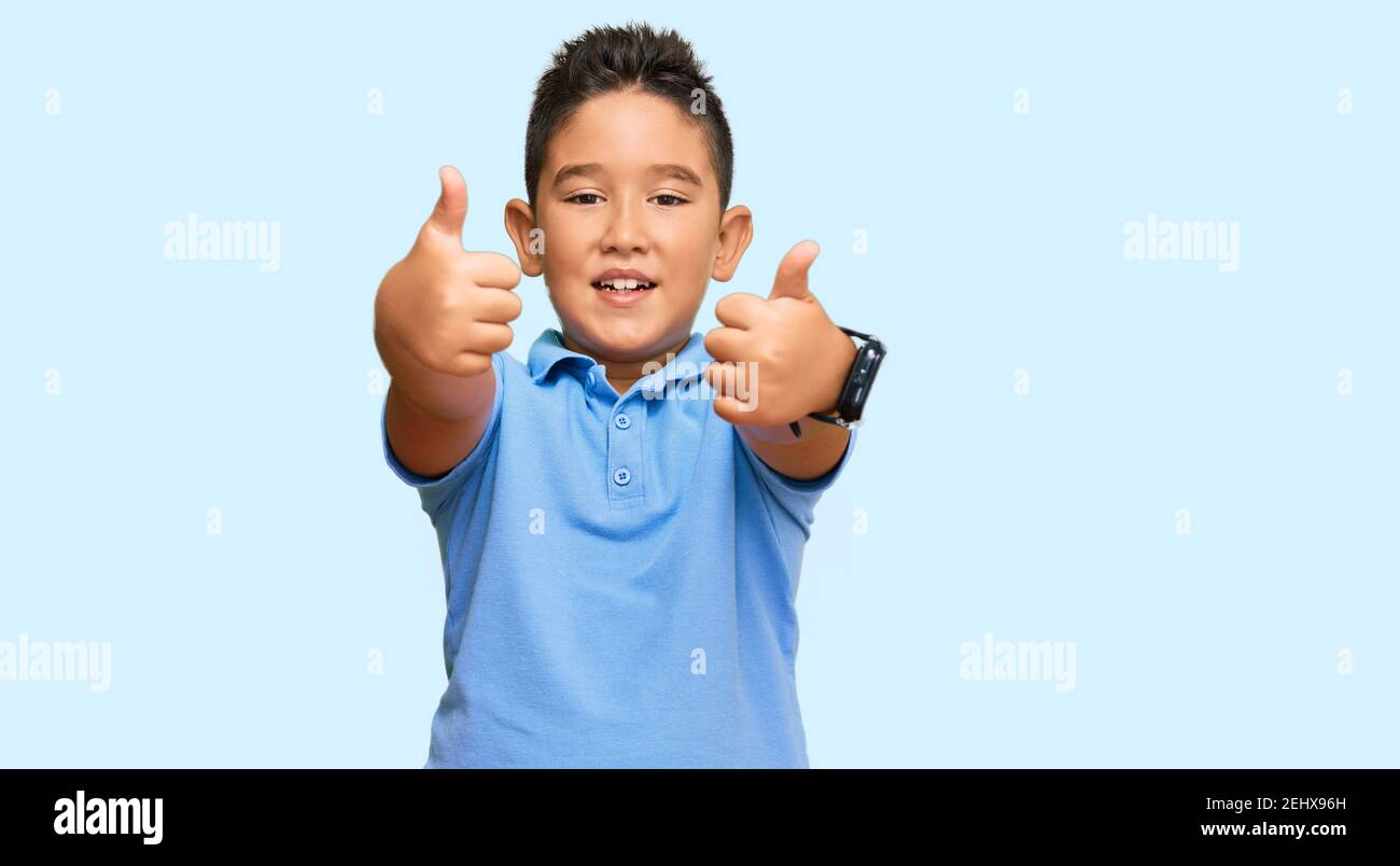 Little boy hispanic kid wearing casual clothes success sign doing ...