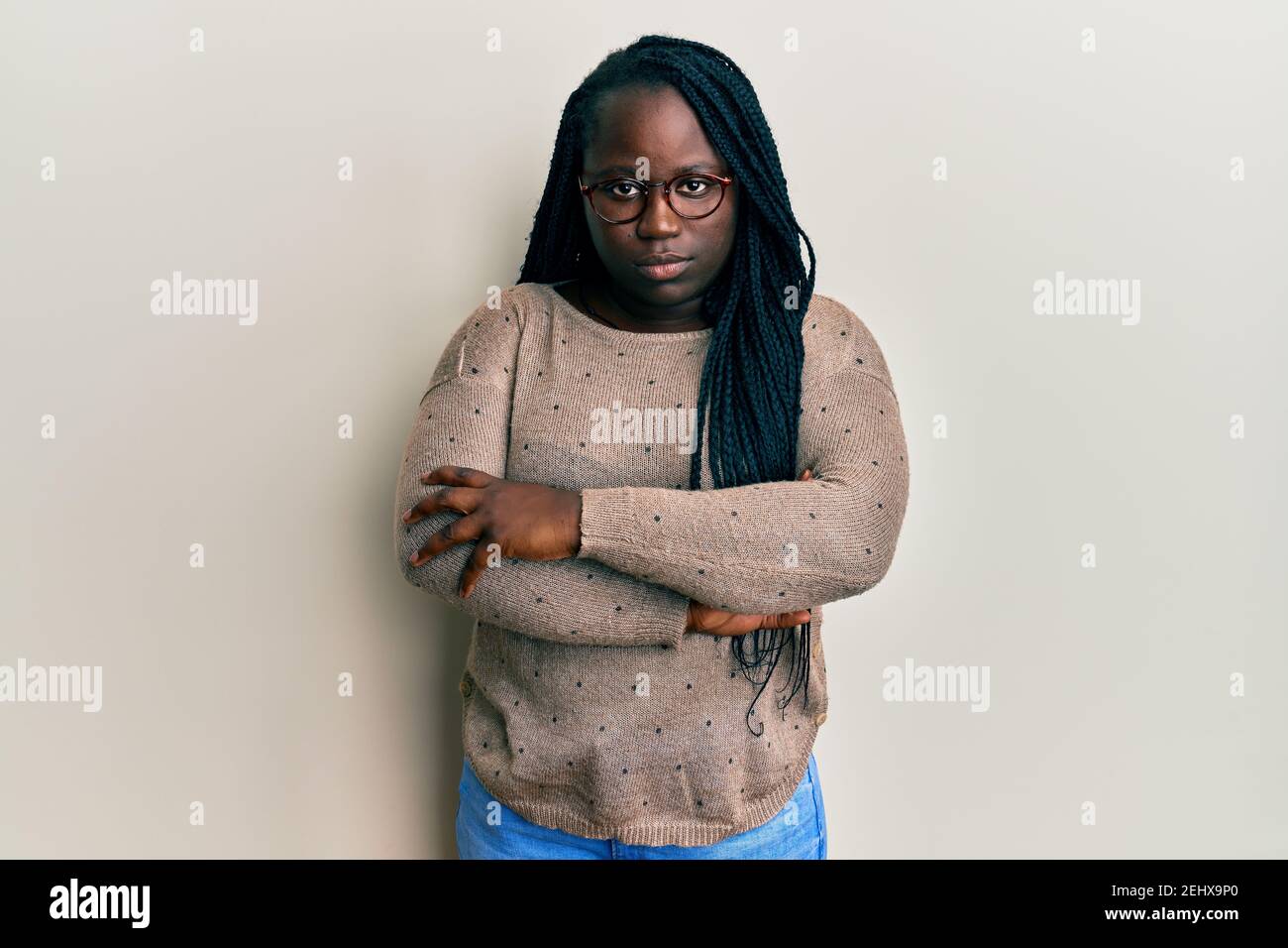 Young black woman with braids wearing casual clothes and glasses ...