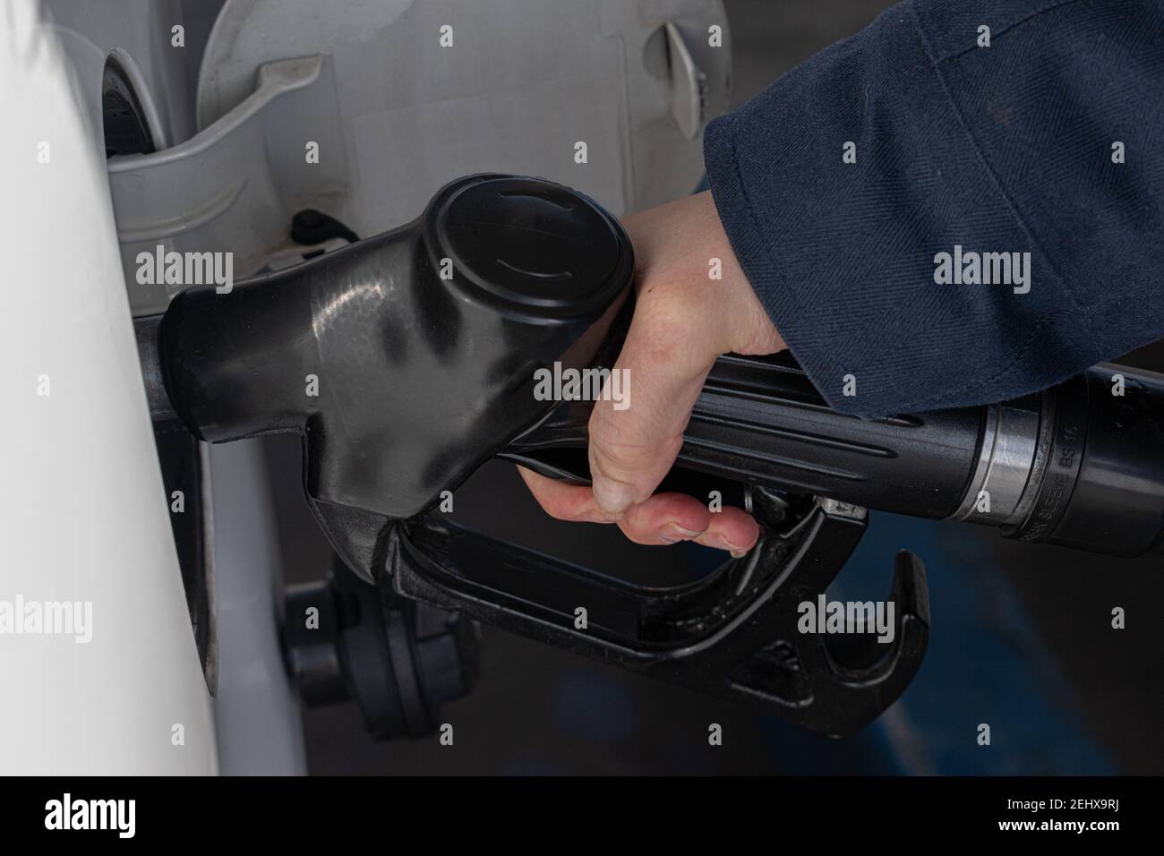 Pouring gasoline with the pump hose to fill the vehicle's tank Stock ...