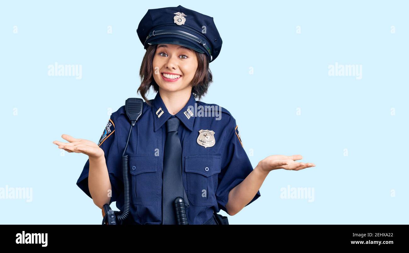 Young beautiful girl wearing police uniform clueless and confused ...