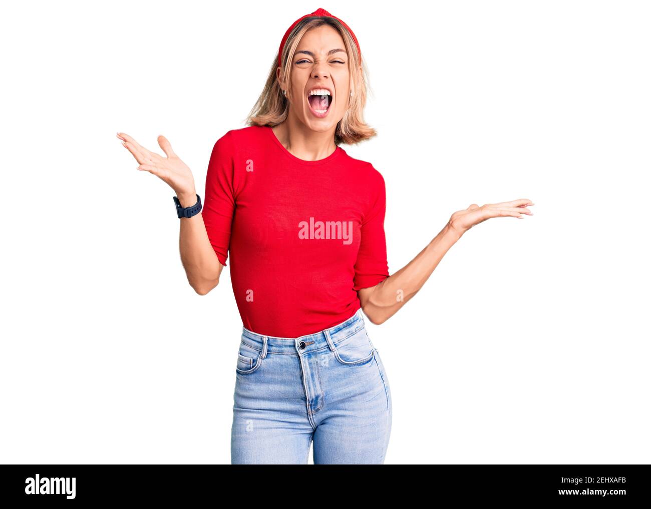Beautiful caucasian woman wearing casual clothes and red diadem crazy ...