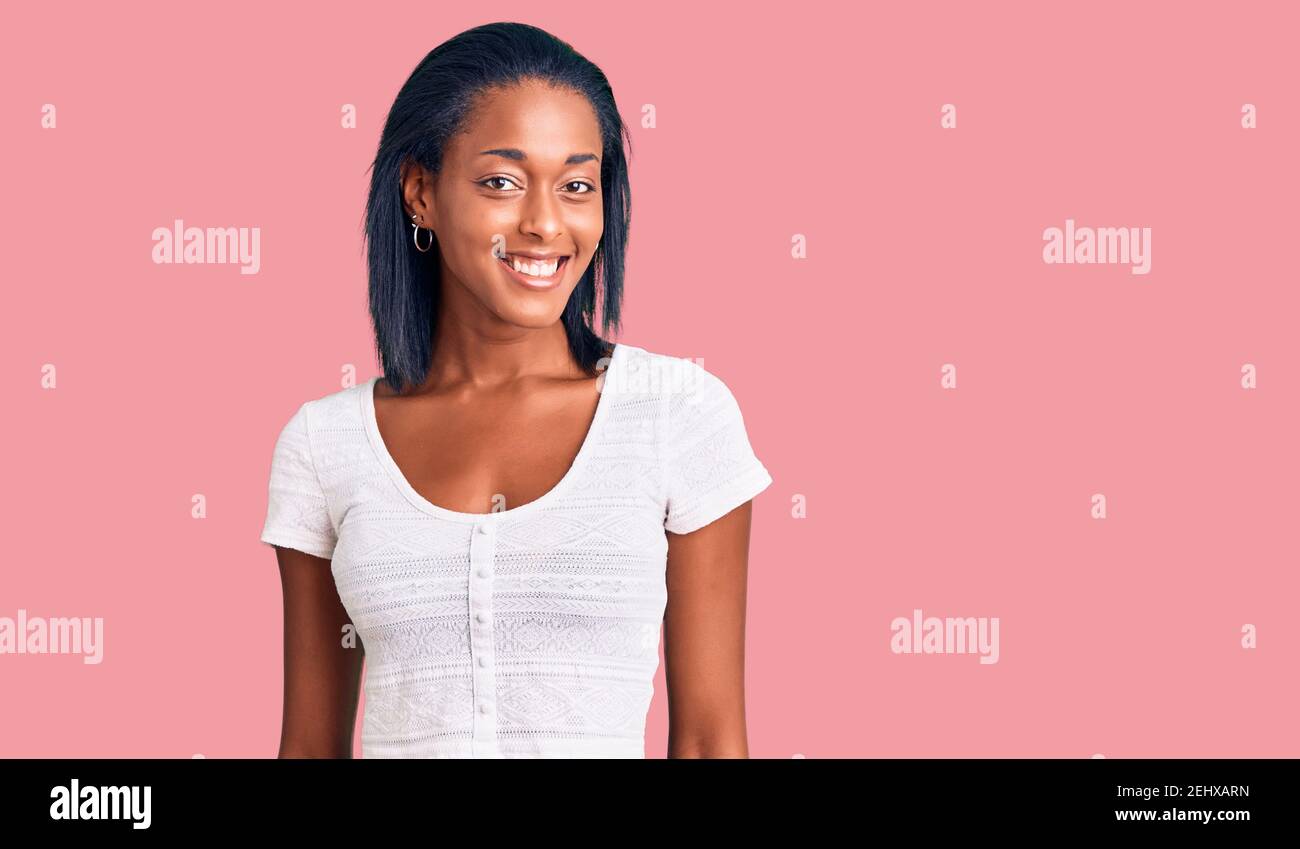 Young african american woman wearing casual clothes looking positive ...