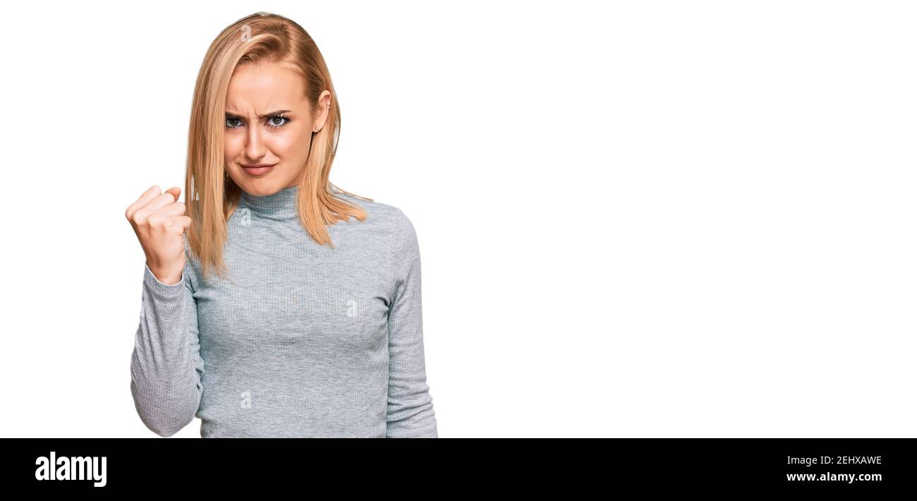 Beautiful caucasian woman wearing casual clothes angry and mad raising ...