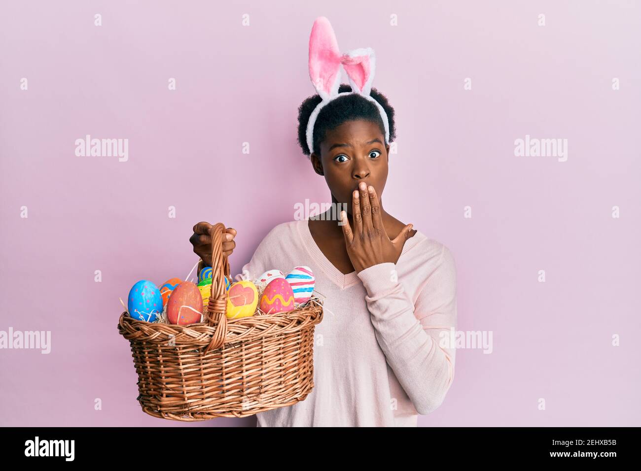 Young african american girl wearing cute easter bunny ears holding ...