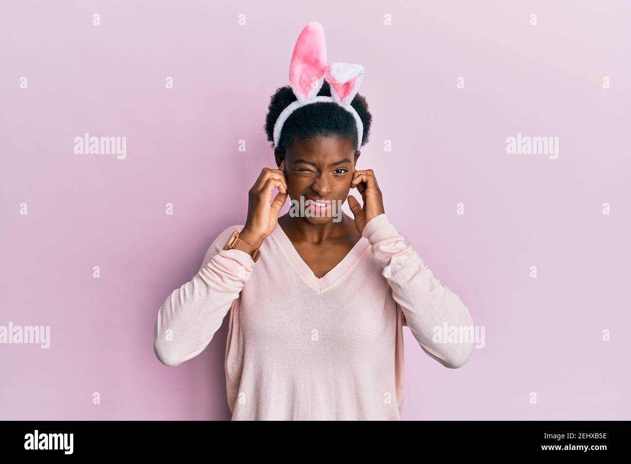 Young african american girl wearing cute easter bunny ears covering ...