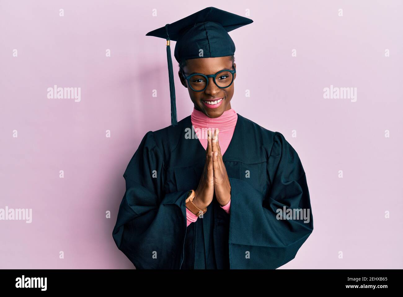 Young african american girl wearing graduation cap and ceremony robe ...