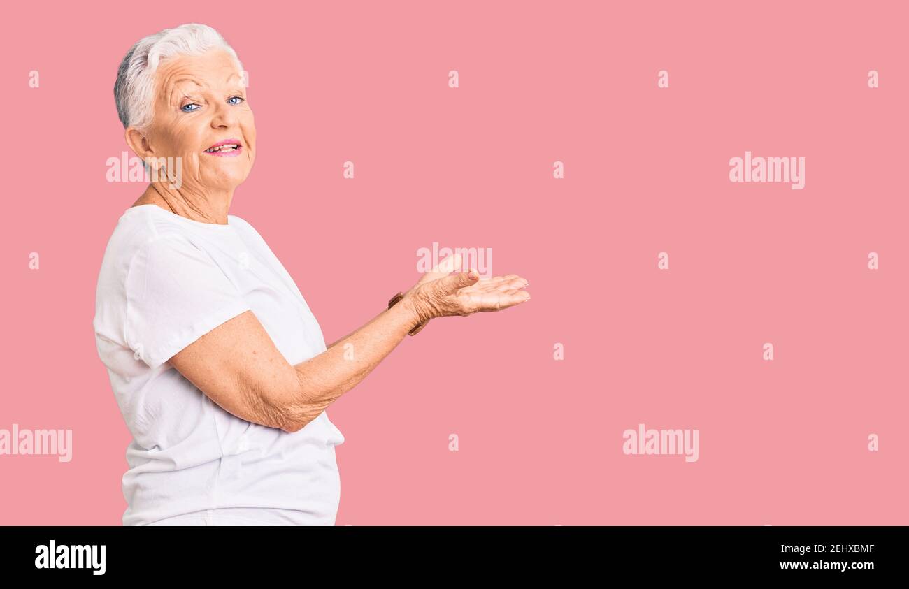 Senior beautiful woman with blue eyes and grey hair wearing casual ...