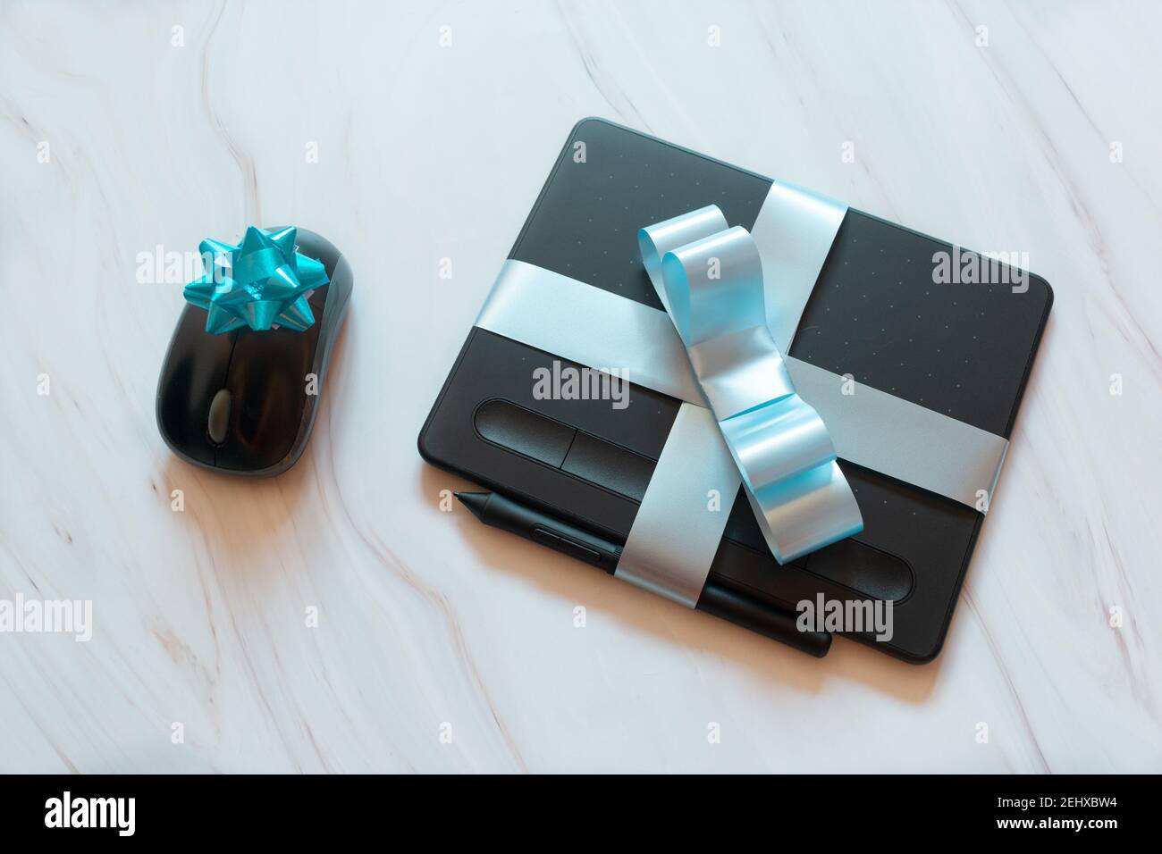 digital tablet and mouse wrapped with blue ribbons Stock Photo - Alamy