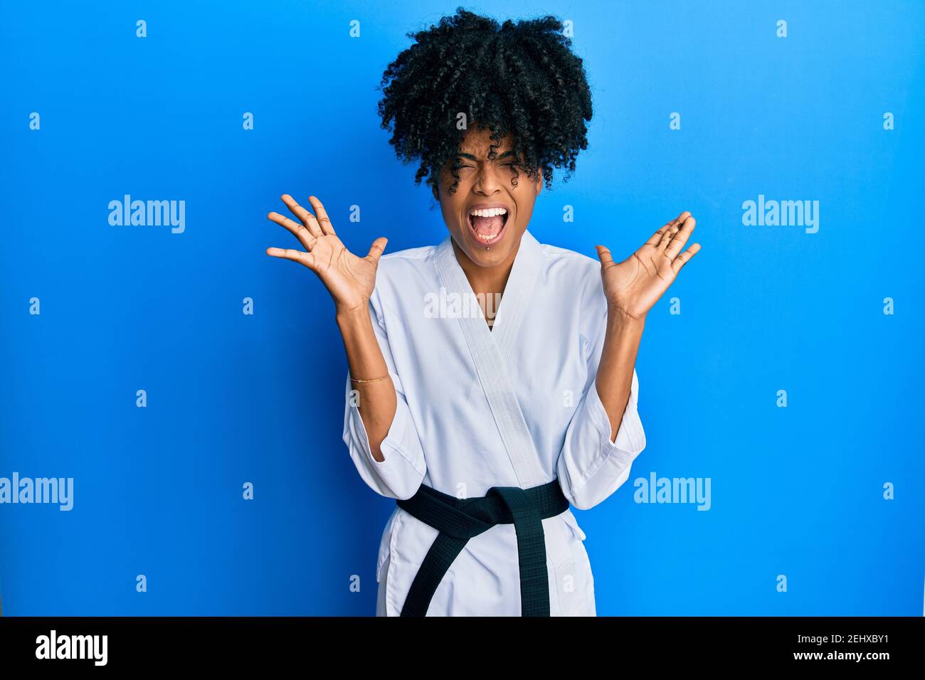 African american woman with afro hair wearing karate kimono and black ...