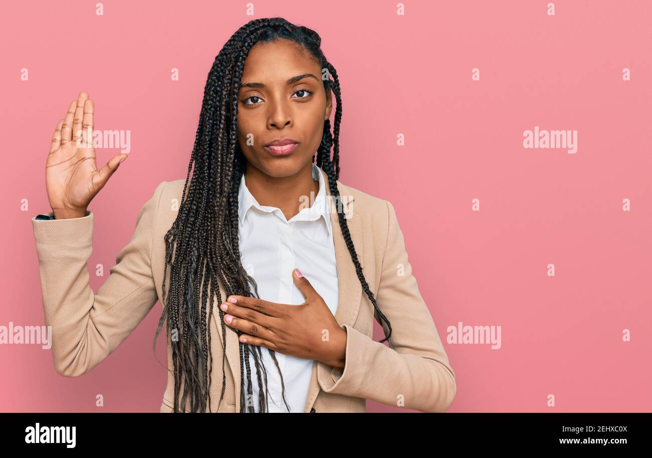 African american woman wearing business jacket swearing with hand on ...
