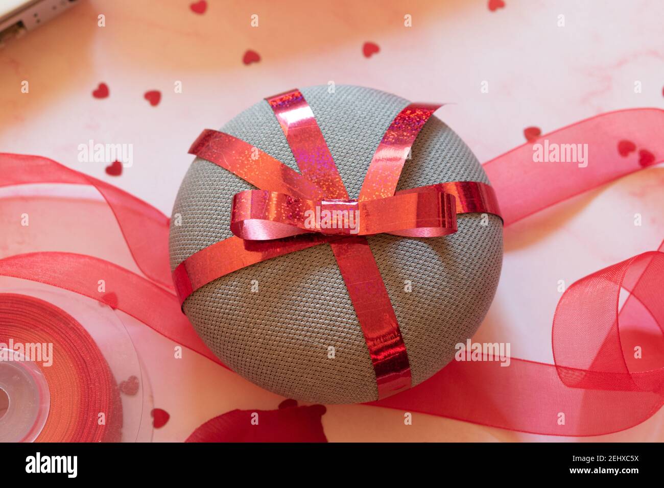 smart speaker wrapped with red gift bow Stock Photo - Alamy