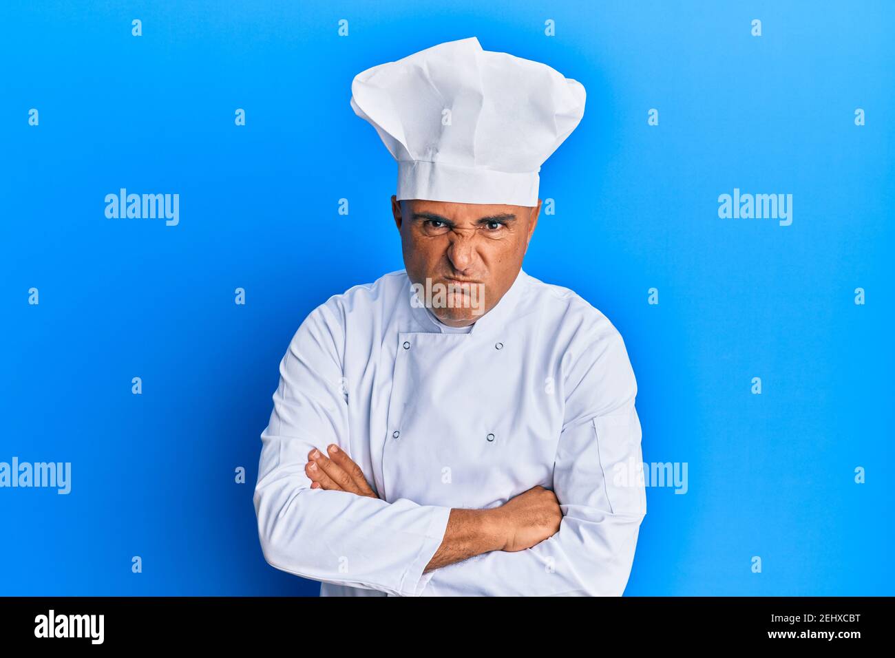 Mature middle east man wearing professional cook uniform and hat ...